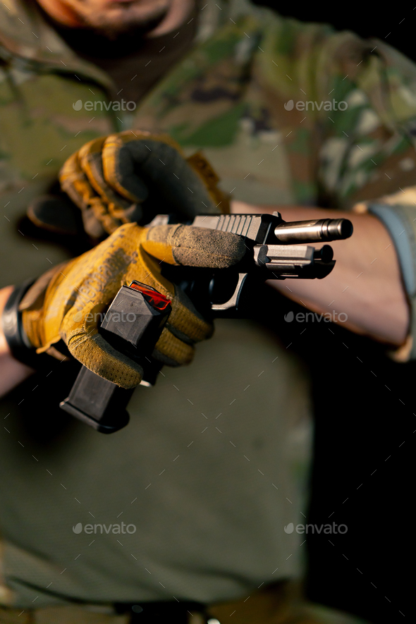 close-up at a professional shooting range a military trainer reloading ...
