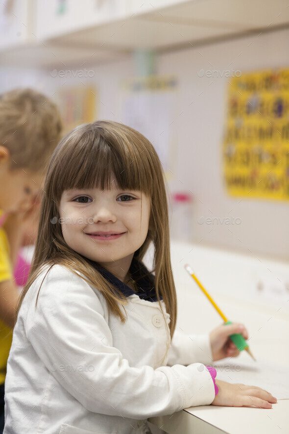 Toddler writing in classroom Stock Photo by Image-Source | PhotoDune