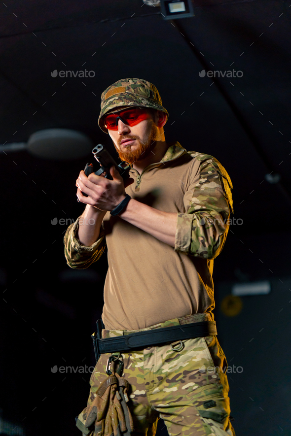 at a professional shooting range military ammunition trainer stands ...