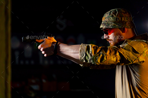 close up at a professional shooting range a military trainer reloading ...