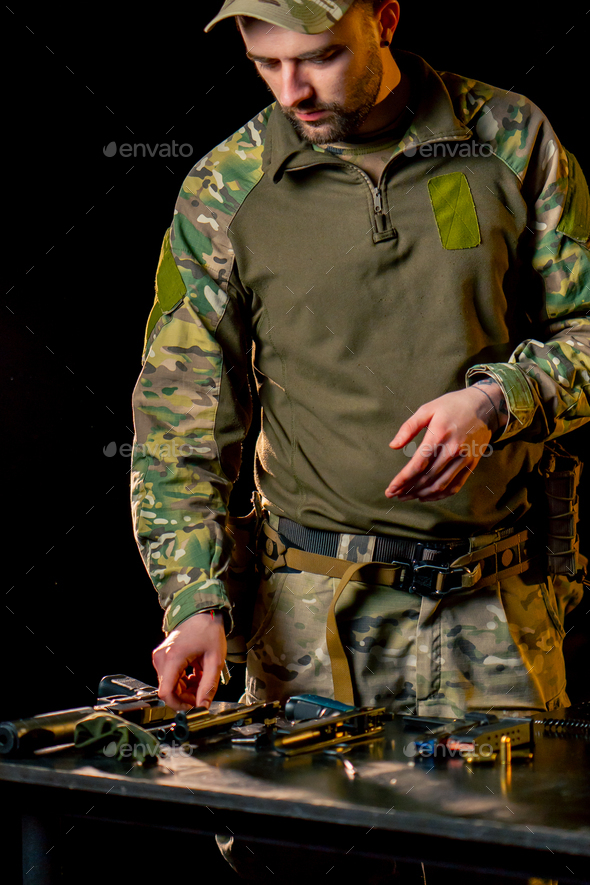 in a professional shooting range professional fighter assembles pistol ...