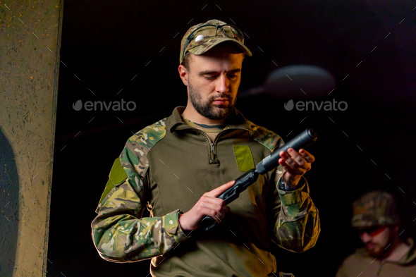 in a professional shooting range professional fighter assembles pistol ...