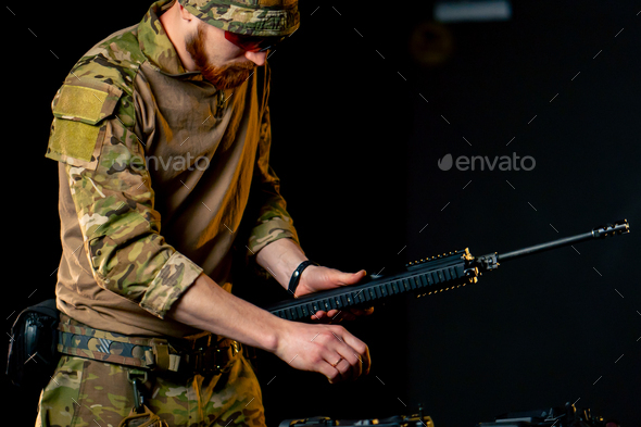 in a professional shooting range professional fighter assembles a NATO ...