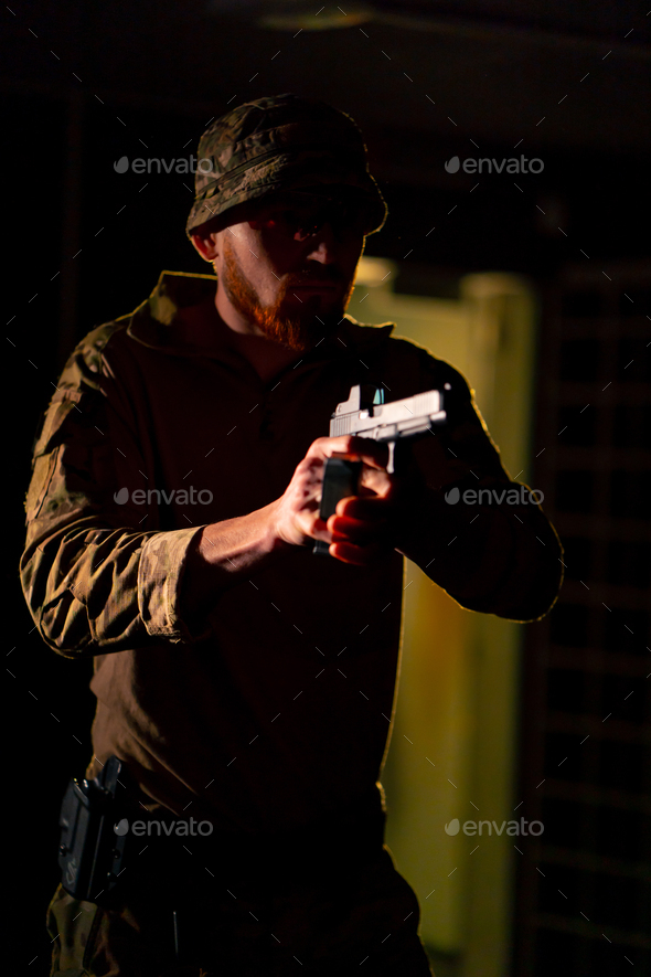 at a professional shooting range a military trainer reloading a pistol ...