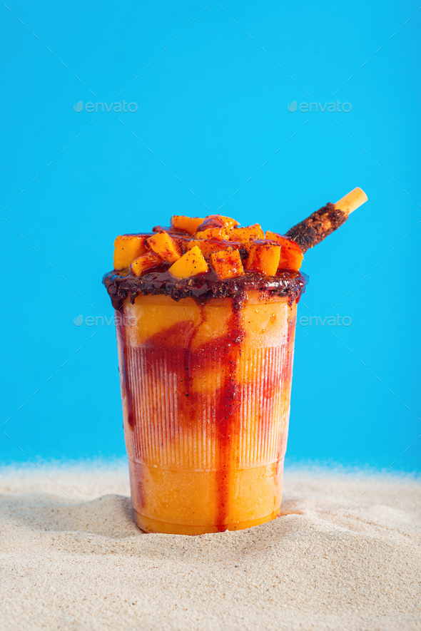 Mangonada, typical mexican mango smoothie on summer background. Stock ...