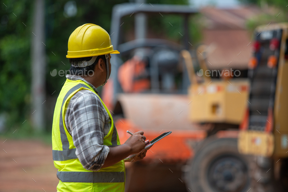 Asphalt road construction supervision engineer Stock Photo by sutipond
