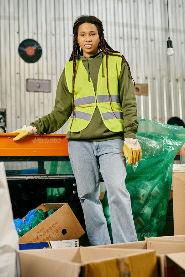 Eco warrior sorting waste in warehouse Stock Photo by LightFieldStudios