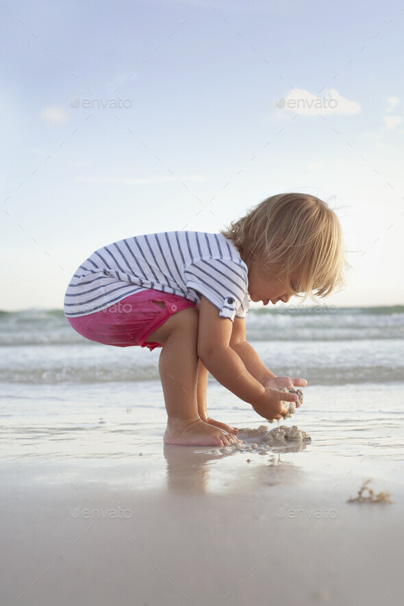 Boy exploring on the beach at sunset Stock Photo by Image-Source ...