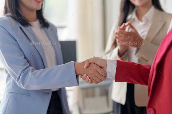 Businesswomen in formal attire shaking hands, close-up. Colleague ...