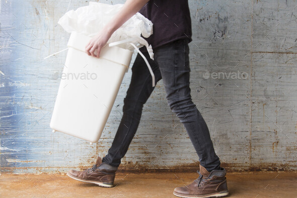 Teenage boy carrying bin with recyclable paper waste Stock Photo by ...