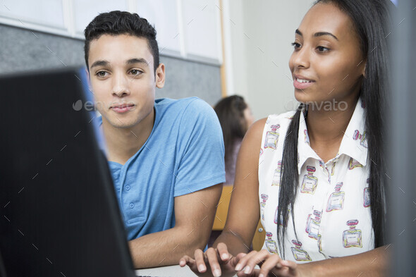 Two teenagers working on computer in high school class Stock Photo by ...