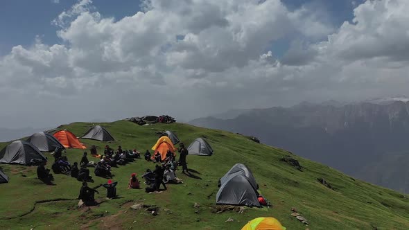 Colorful Tents And Hikers Gathered In Circle Near A Cliffside In Sar ...