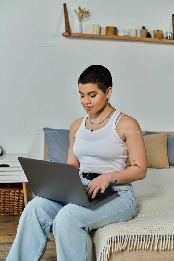 Modern muse: woman embracing technology on bed Stock Photo by ...