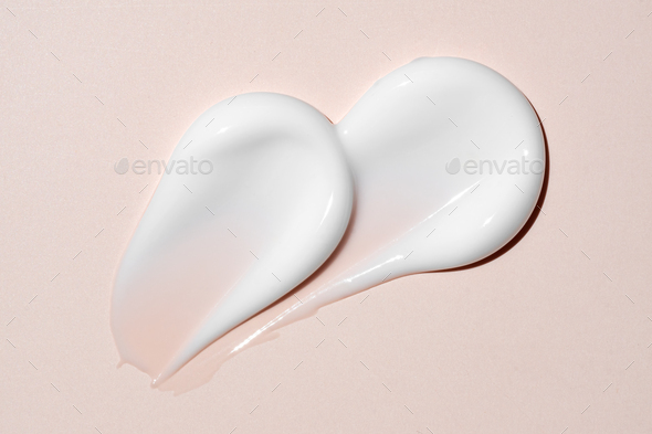 Cosmetic product smear white moisturizing lotion isolated on beige ...