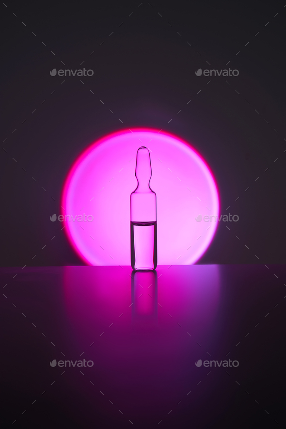 Several ampoules for injection with medicines on a lilac background ...