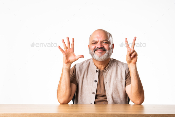 Indian asian retired old man counting numbers using fingers and showing ...