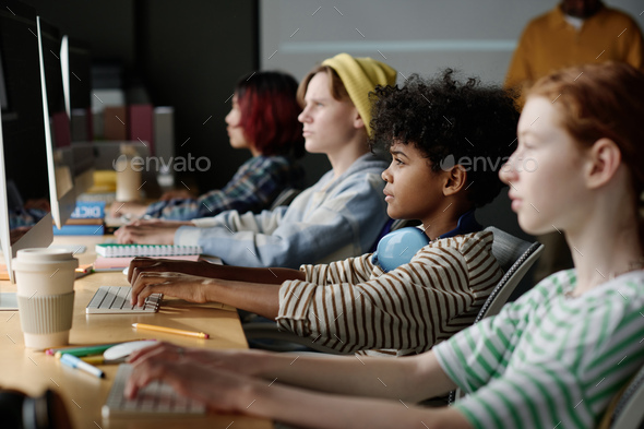 Group of Kids Coding On Computers In Class Stock Photo by AnnaStills