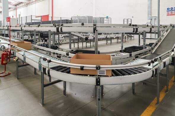 packing line in a logistics warehouse - conveyor belts inside a ...