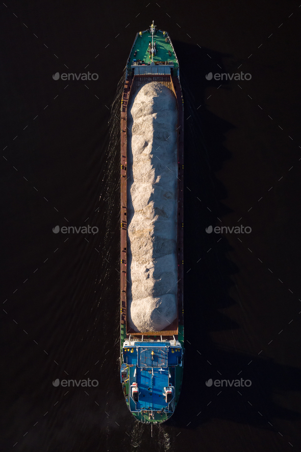 An aerial drone photo of a container cargo ship carrying load in ...