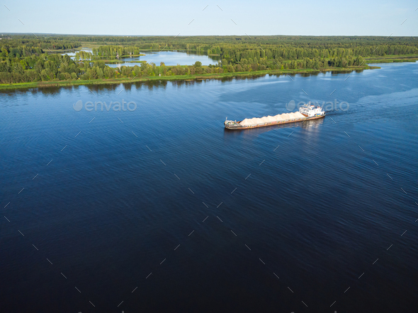 An aerial drone photo of a container cargo ship carrying load in ...