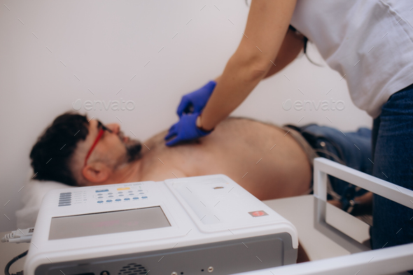 ECG electrodes on mature male patient in hospital before surgery ...