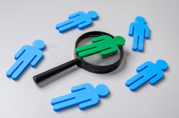 Human figures and magnifying glass. Stock Photo by mohdizzuanbinroslan