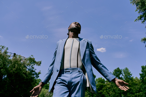 Dapper Gent in Azure: Standing Tall Amidst Verdant Expanse Stock Photo ...
