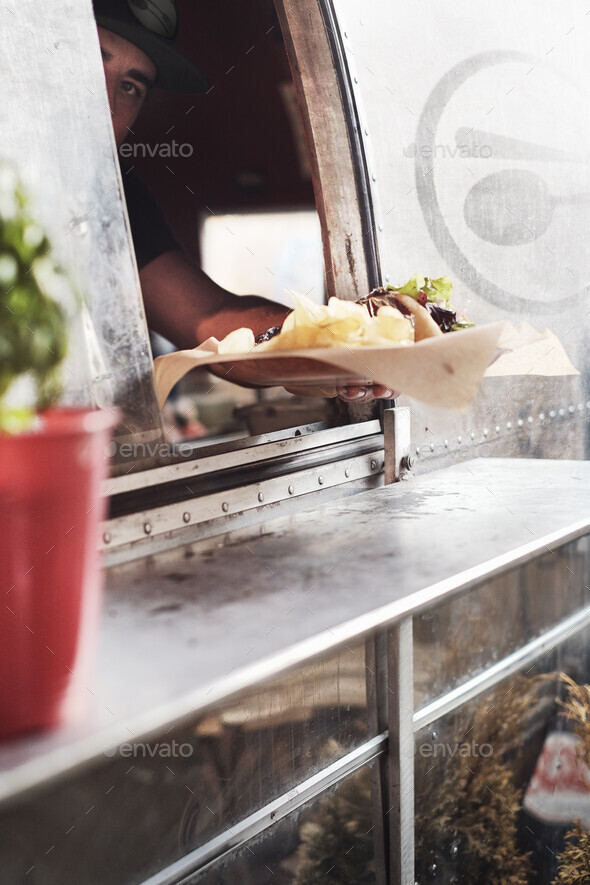 Food being served through window of camper van food truck Stock Photo ...