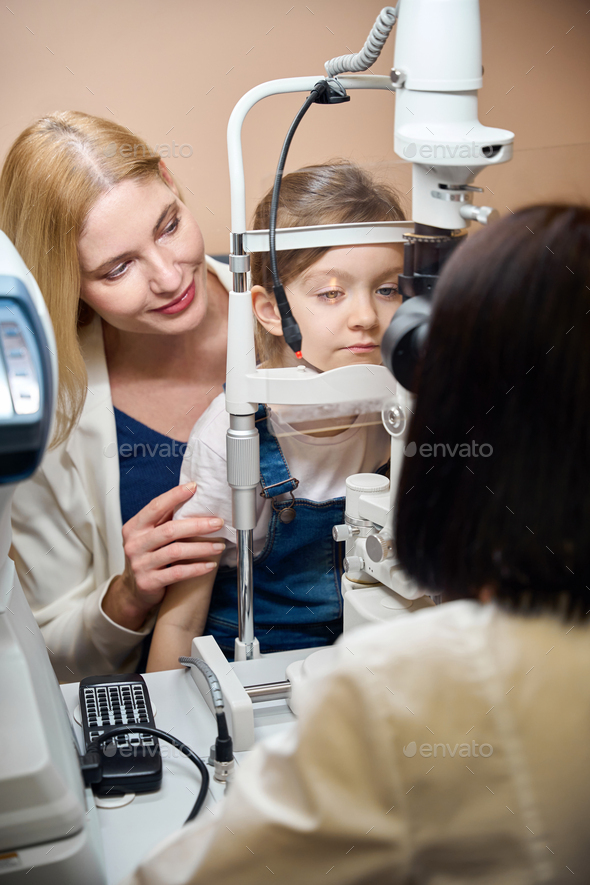 Doctor checks the vision of young patient using modern equipment Stock ...