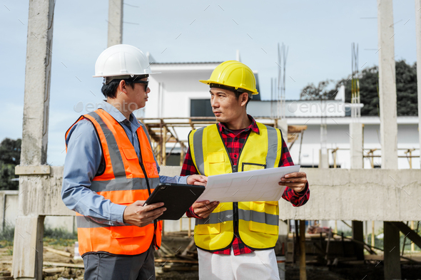 Two male construction workers, including an Asian engineer ...