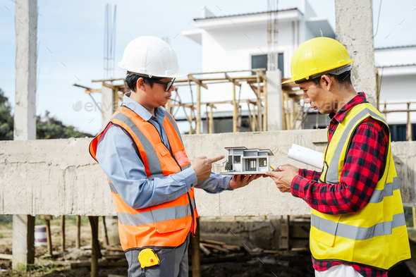 Two male construction workers, including an Asian engineer ...
