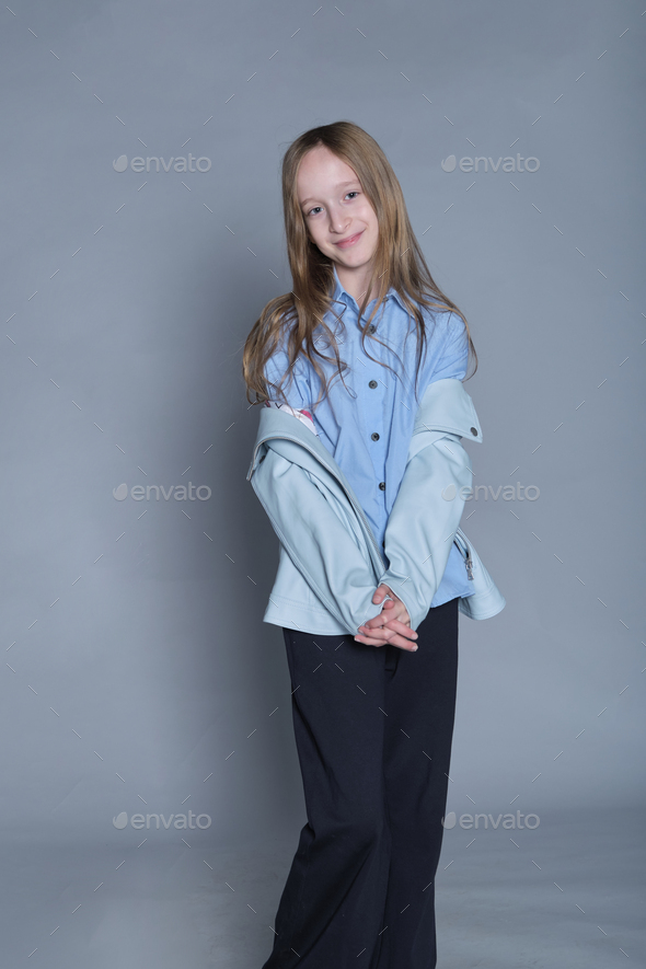 Youthful joy meets chic style in a girl's cheerful pose. A great ...