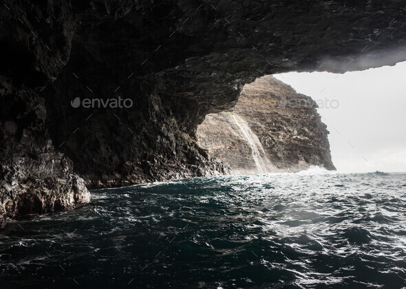 Ocean waves inside a dark cave with a view of a cliff Stock Photo by ...