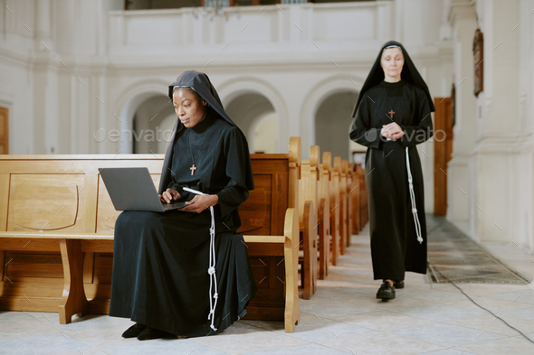 Modern Catholic Sister Using Laptop Stock Photo by AnnaStills | PhotoDune