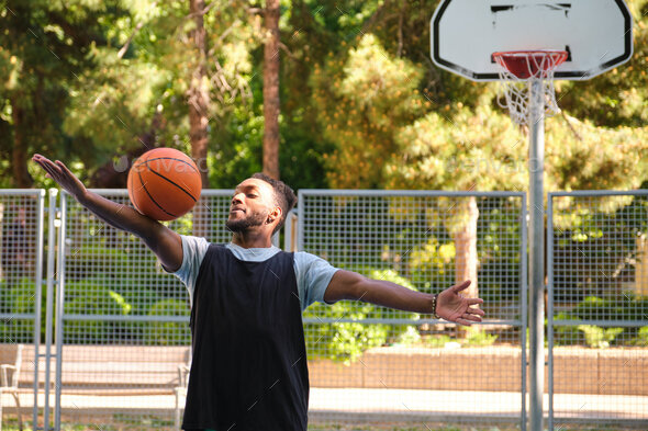 Basketball player balancing ball on back of neck Stock Photo by Ladanifer