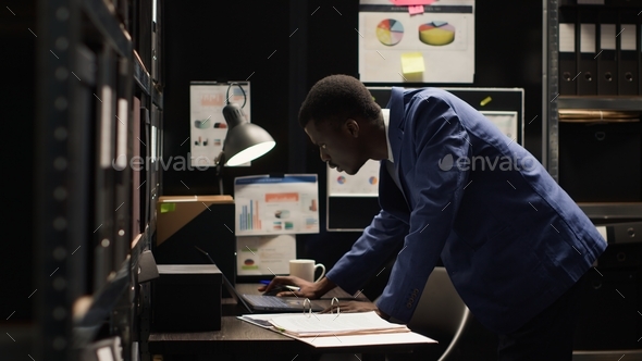 Detective inspecting evidence in office Stock Photo by DC_Studio ...