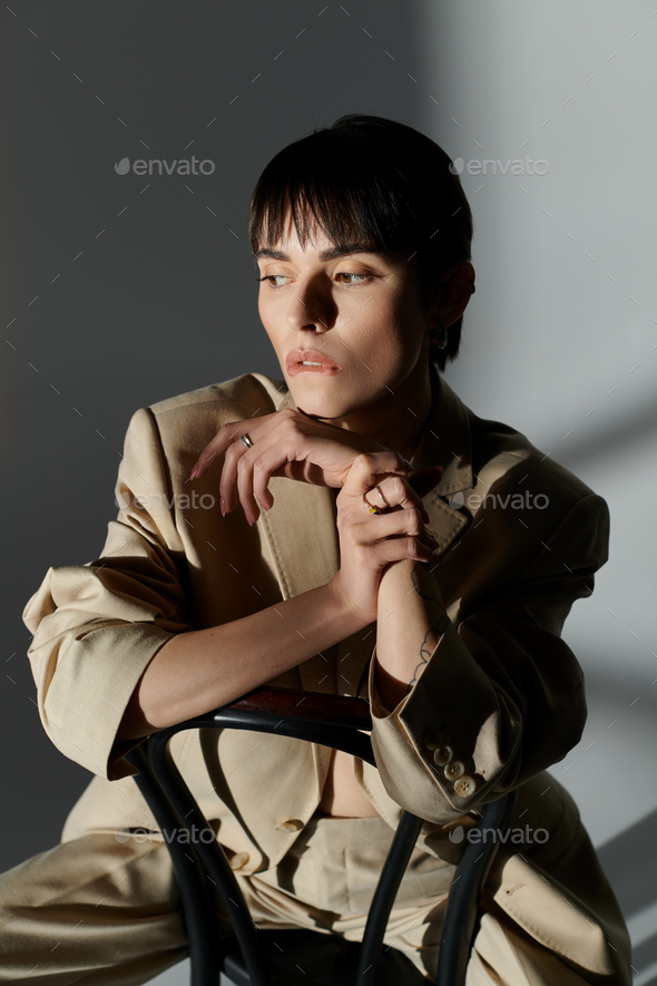 A Moment of Reflection: Woman Poses in a Tan Suit Stock Photo by ...