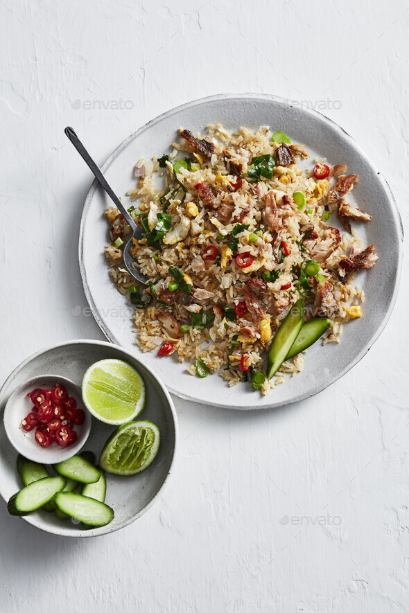 Plate of fried rice with garnishes on the side Stock Photo by Image-Source