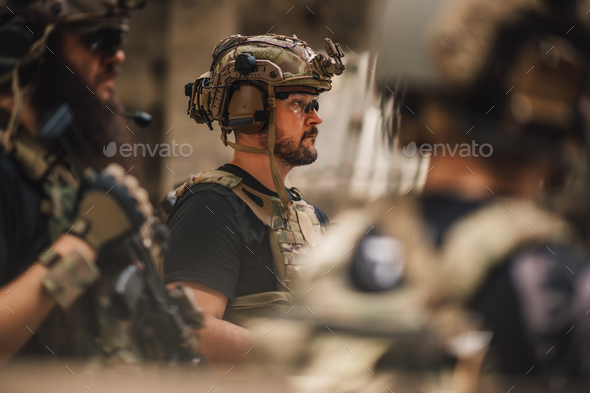 Group of soldiers listening commander in ruins during rescue operation ...