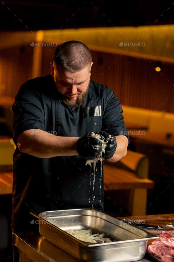 restaurant in a rib bar in the central hall chef in black gloves ...