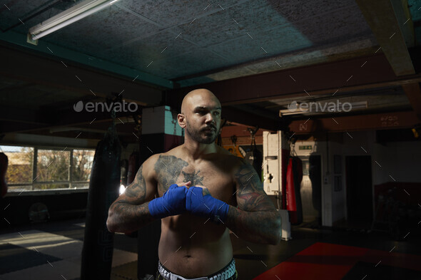 Shirtless boxer with wrapped hands in gym Stock Photo by Image-Source