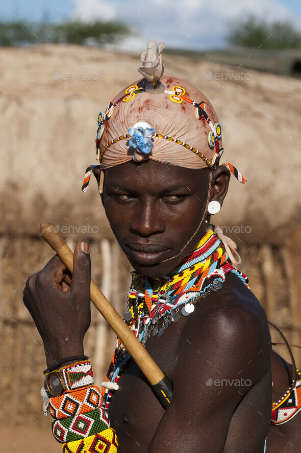 Man in traditional attire playing a flute outdoors Stock Photo by Image ...
