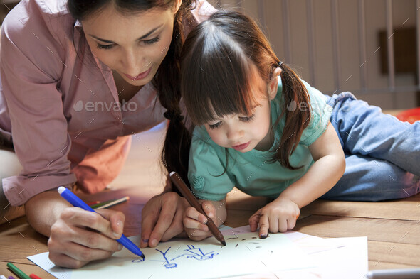 Adult helping child with drawing activity Stock Photo by Image-Source