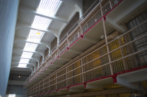 Interior view of a multilevel prison cell block with a focus on the ...