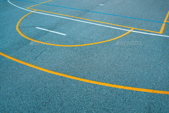 Outdoor basketball court lines and markings on concrete flooring ...