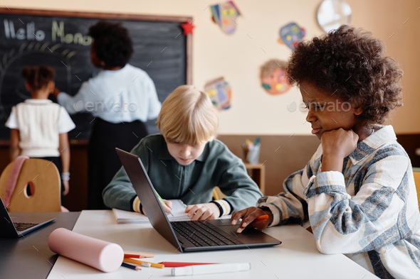 Studious Kid Using Educational Technology Stock Photo by seventyfourimages