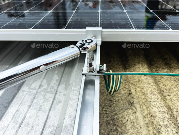 Testing the torque of the solar panel mounting rail nuts. Stock Photo ...