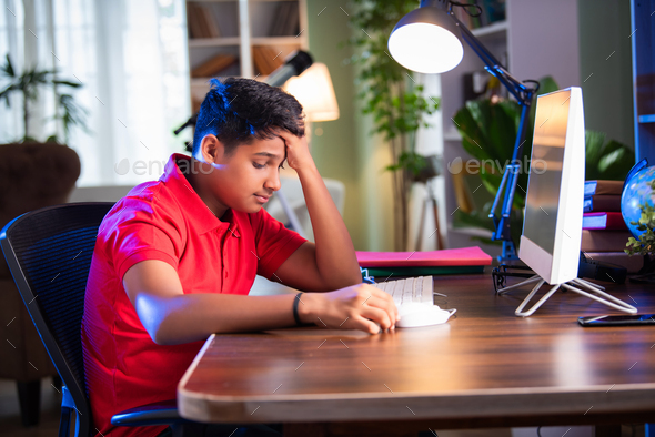 Stressed Asian Indian Teenage School Boy Learning Virtually at Home ...