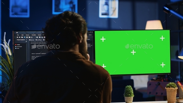 Programmer typing complex code on green screen computer in neon lit home office Stock Photo by ...