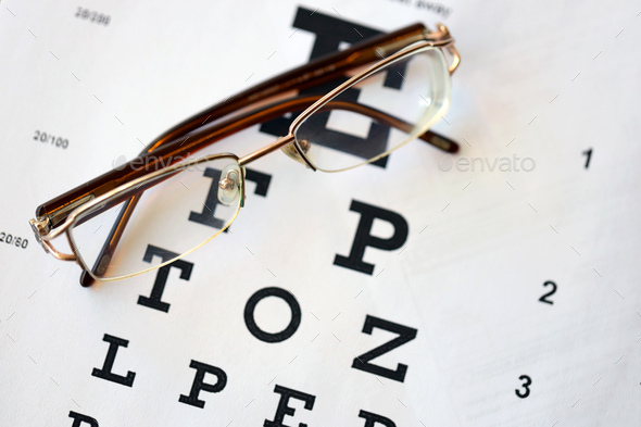 spotted eyeglasses on eyesight test chart isolated on white Stock Photo ...